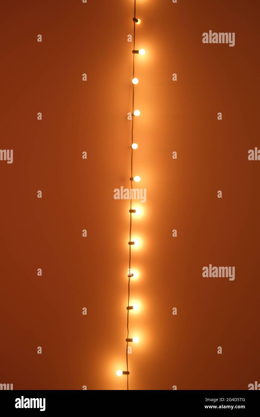A link of light bulbs on the wall Stock Photo - Alamy