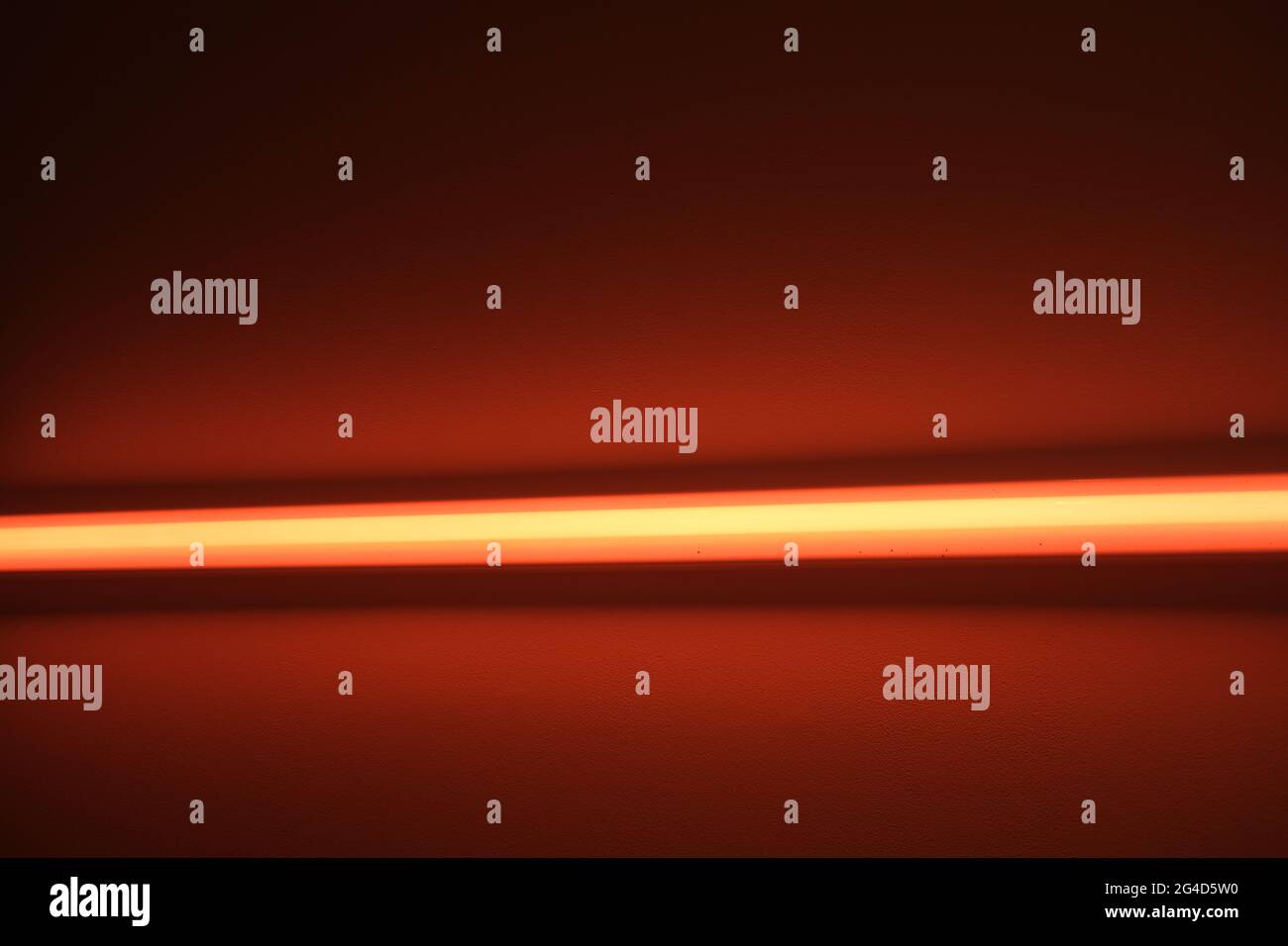Orange LED bar on a wall Stock Photo - Alamy