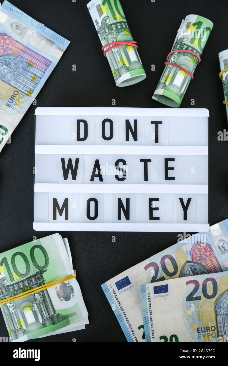 Lightbox board with word DONT WASTE MONEY in black letters around euro ...