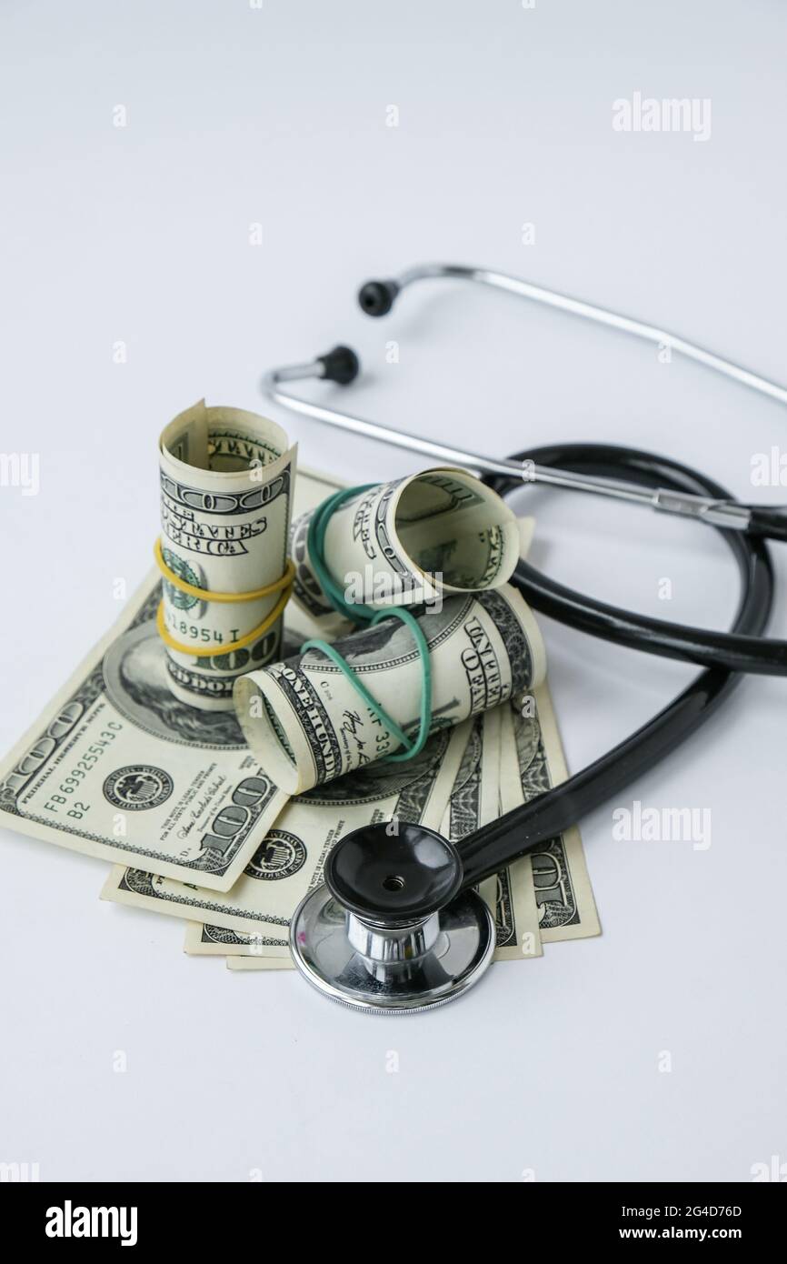 Stack of cash dollars and stethoscope. The concept of medical expensive ...