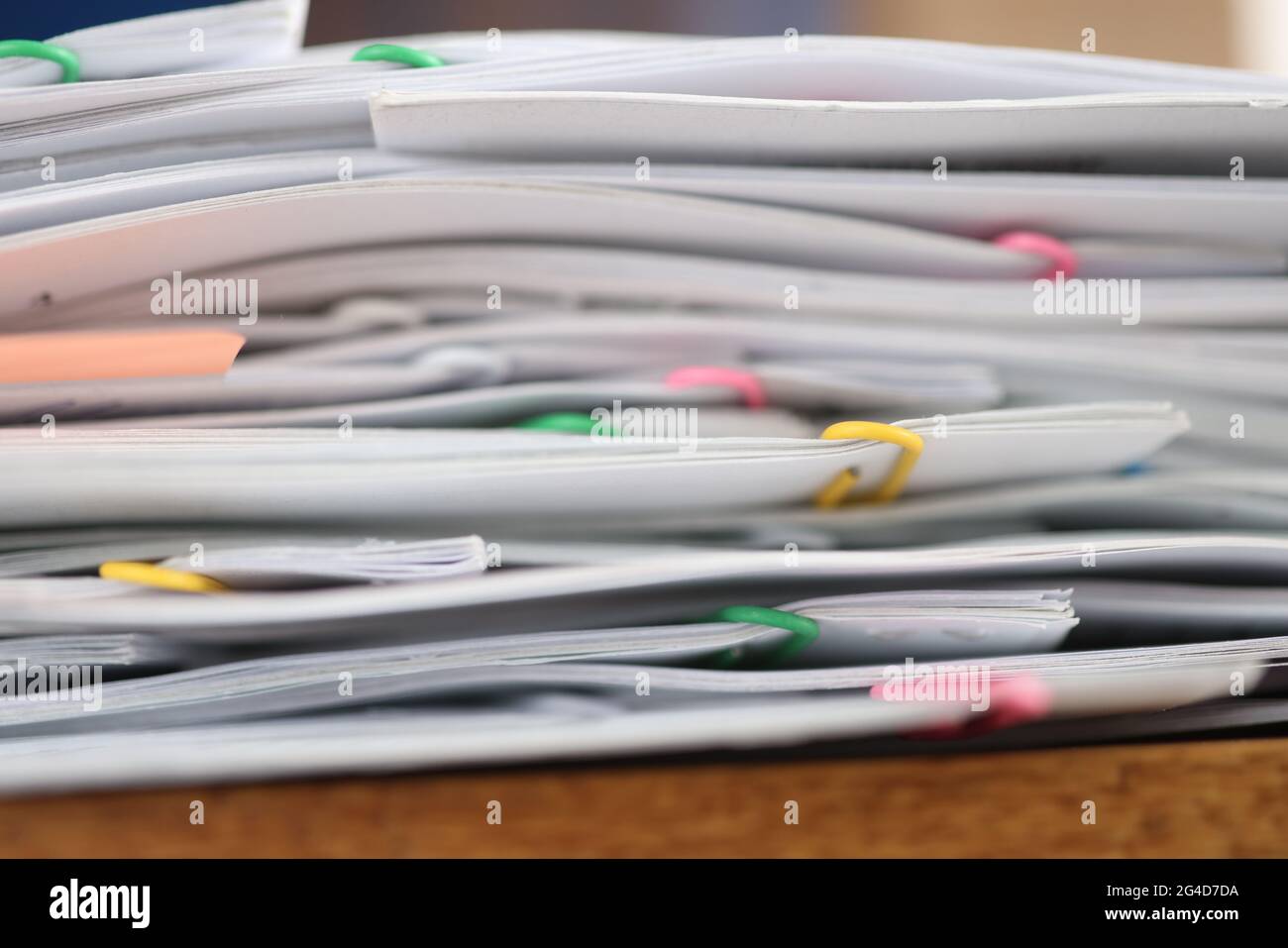Stack of reporting paper documents on desktop Stock Photo - Alamy