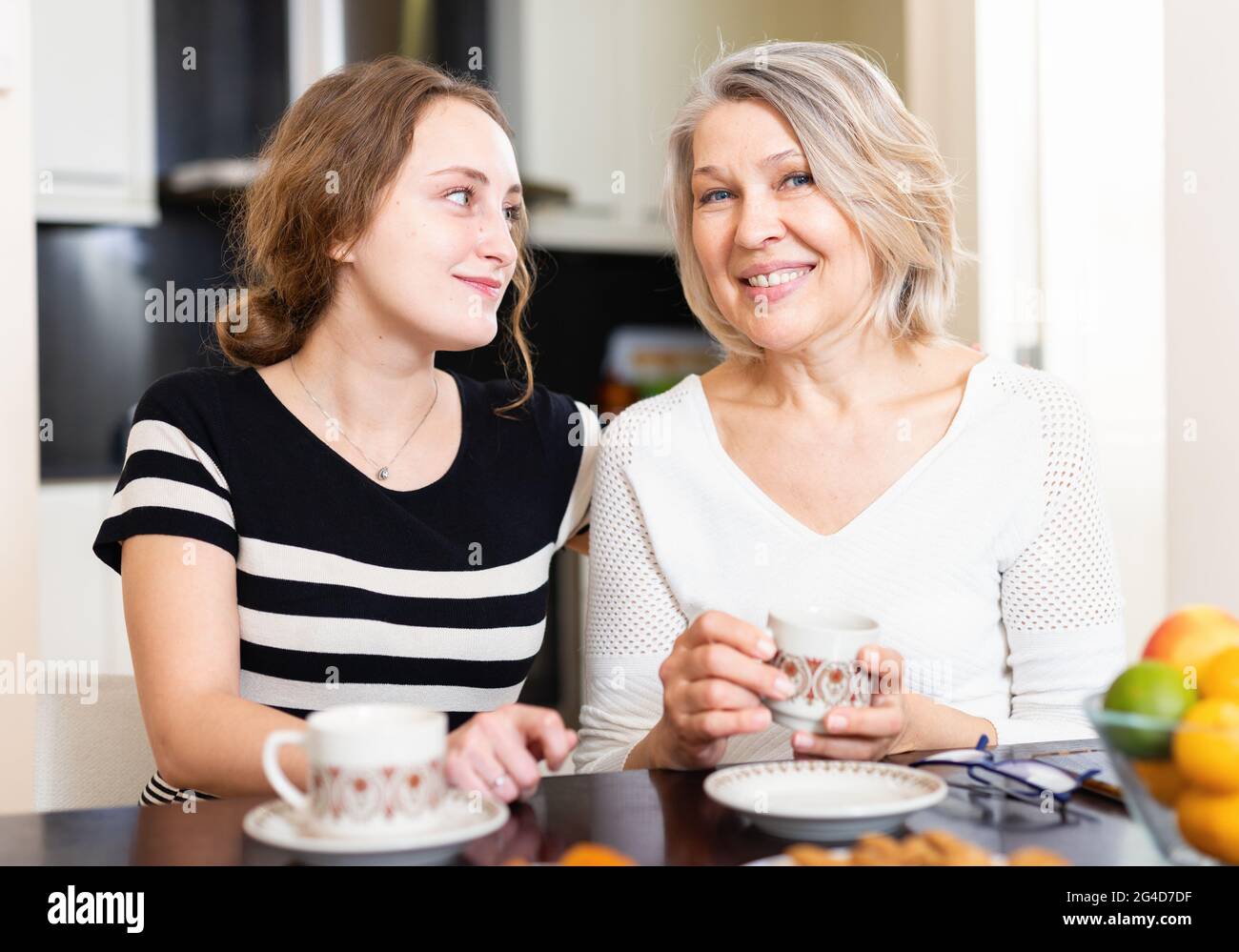Two women talking at table Stock Photo - Alamy