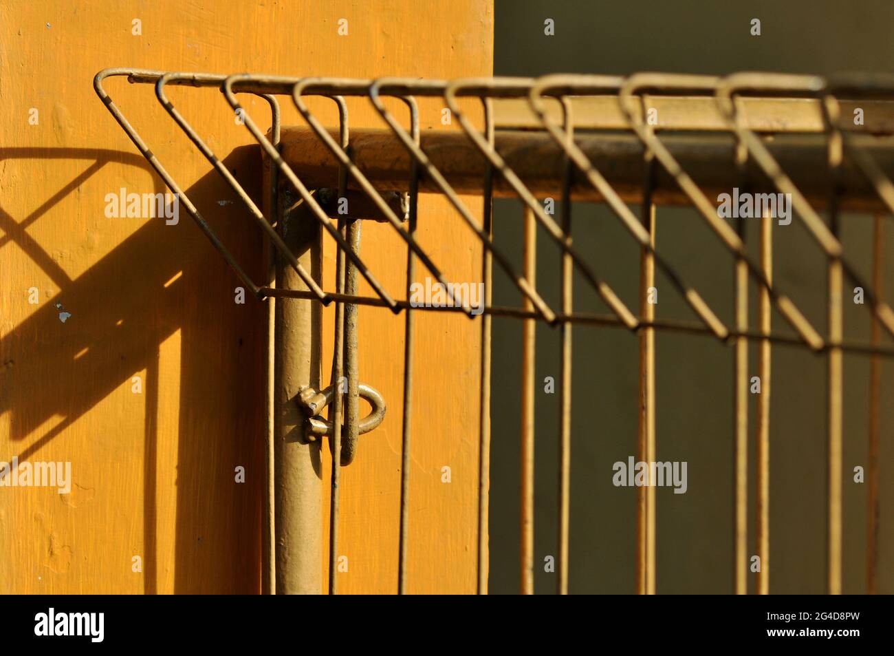 Yellow iron fence in front of the house Stock Photo - Alamy