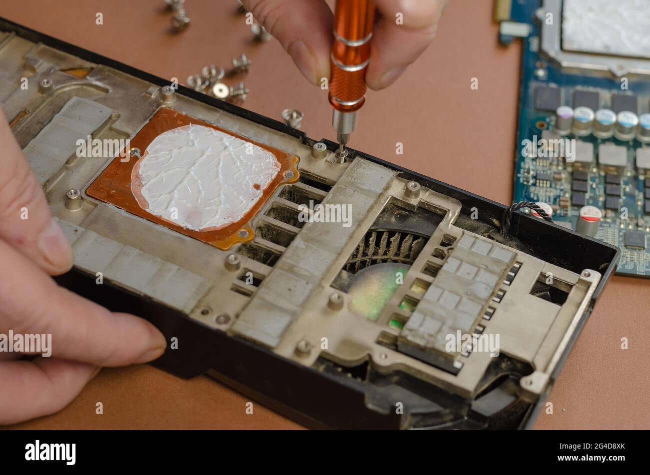 Graphics card on a brown background. Man disassembles computer ...