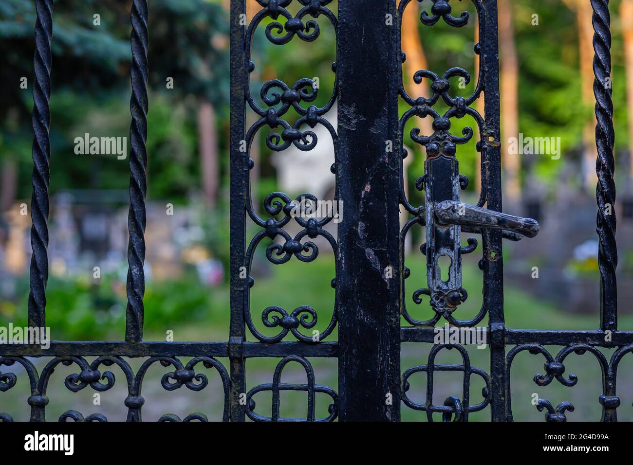 Steel handle of a forged steel gate the cemetery. Picture taken in a ...