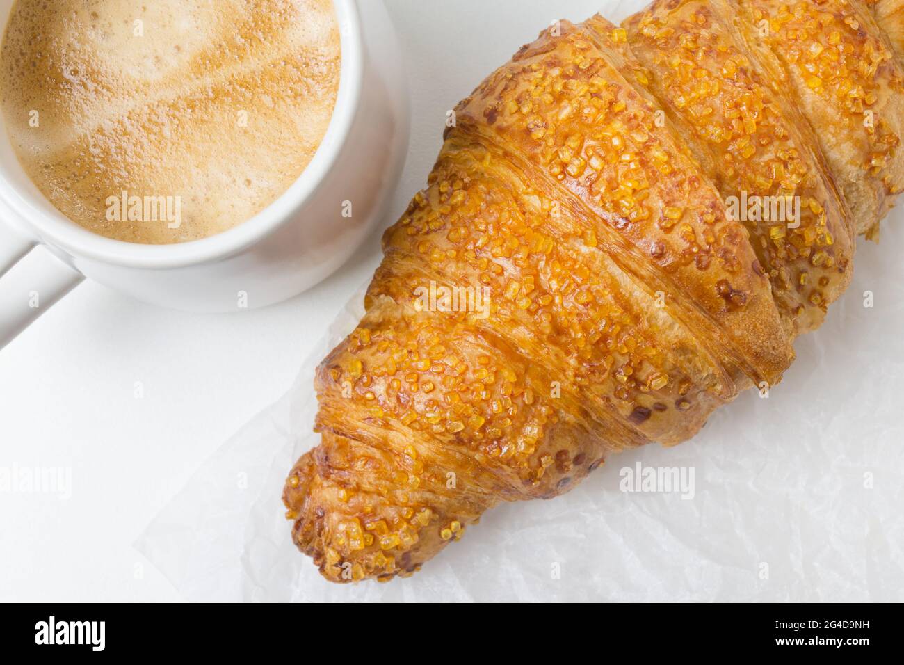 pastry croissant on white paper background with cup of coffee. French ...