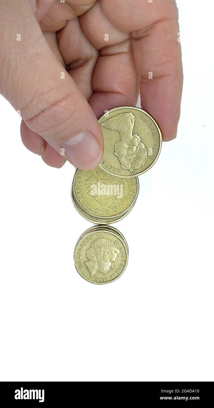 Old hand pick up the Australia coin isolated on white background Stock ...