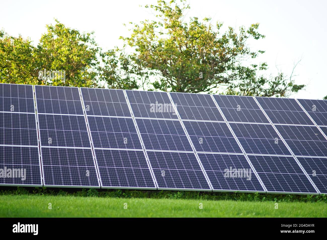 Solar panels station in the summer garden with green grass Stock Photo ...