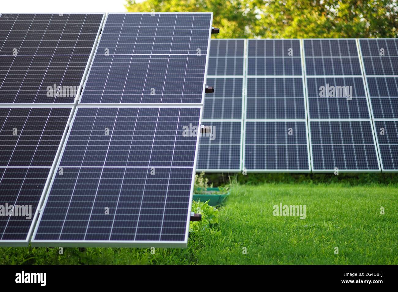 Solar panels stations on the green lawn in summer garden Stock Photo ...
