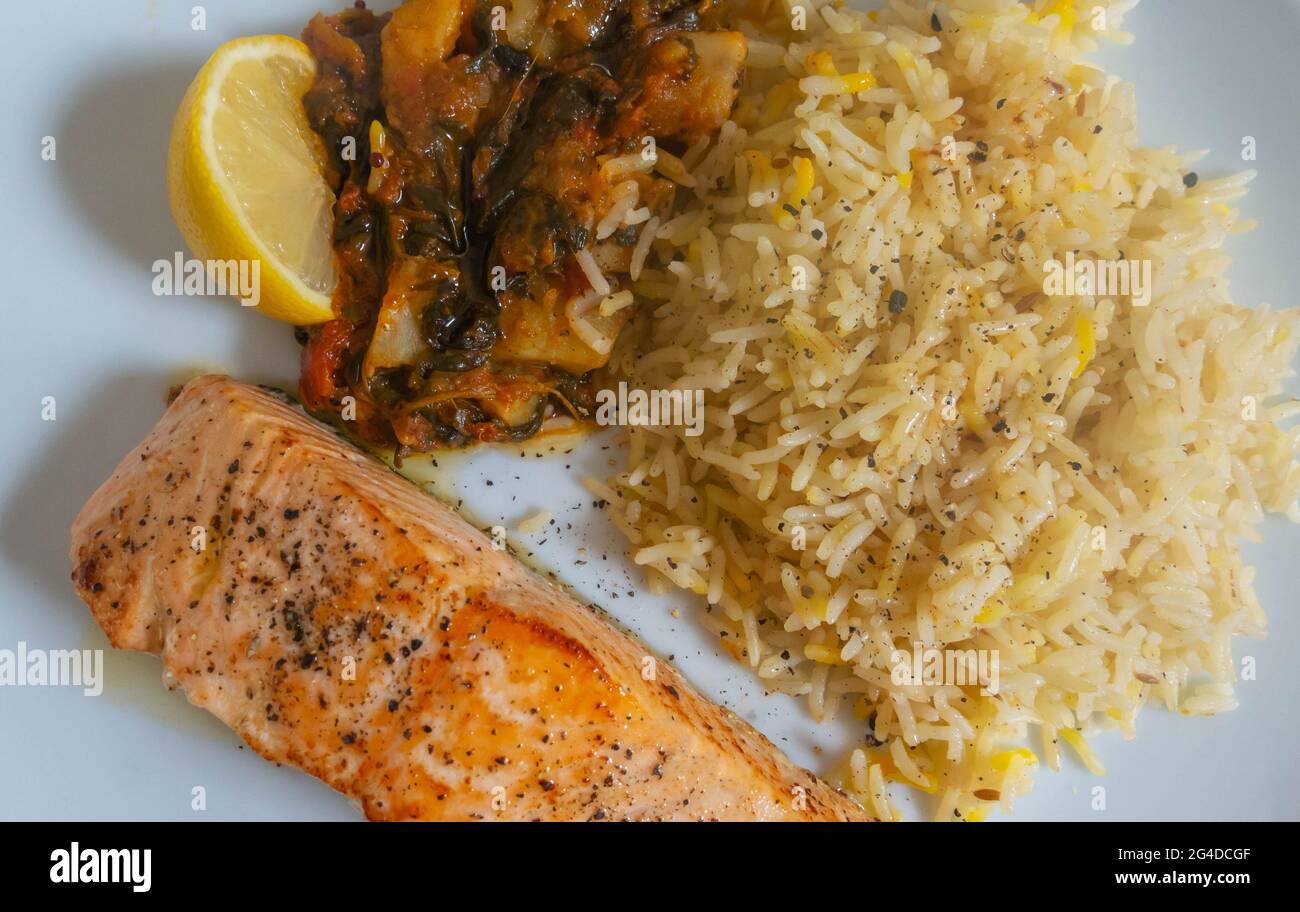 Pan-sheared salmon with rice, spinach, and diced potatoes Stock Photo ...