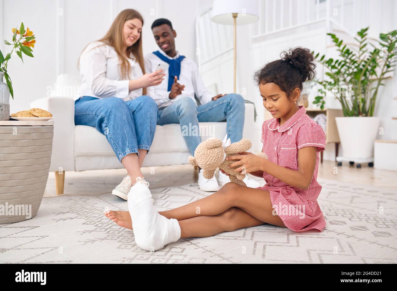 Happy family resting in living room Stock Photo - Alamy