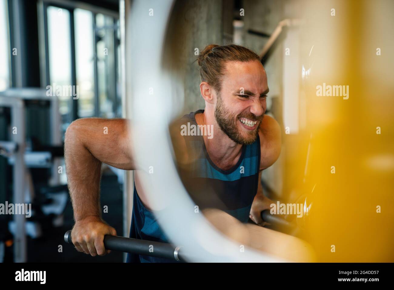 Muscular man working out in gym doing exercises to stay healthy Stock ...