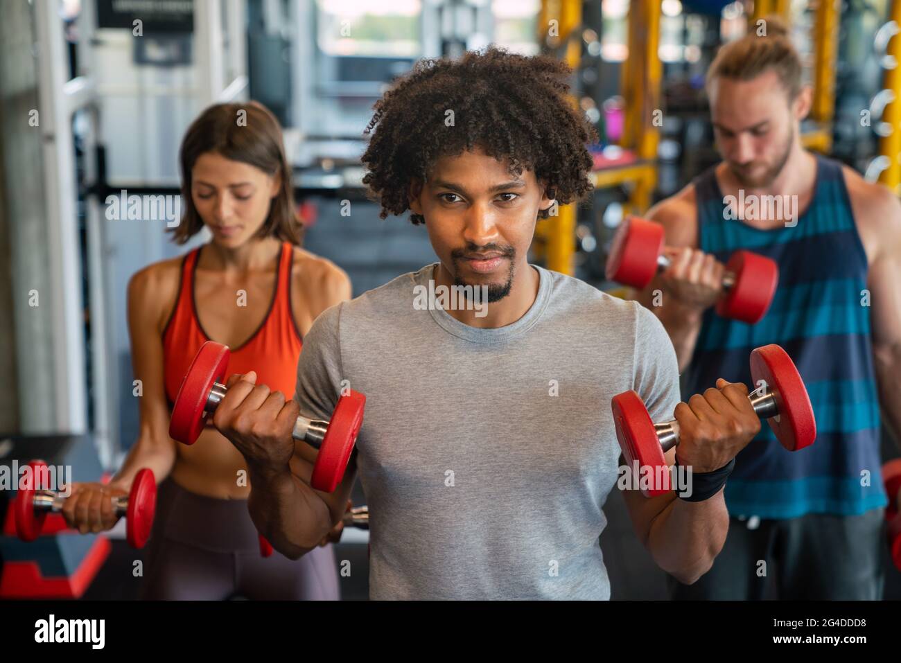 Picture of cheerful fitness team exercise together in gym Stock Photo ...