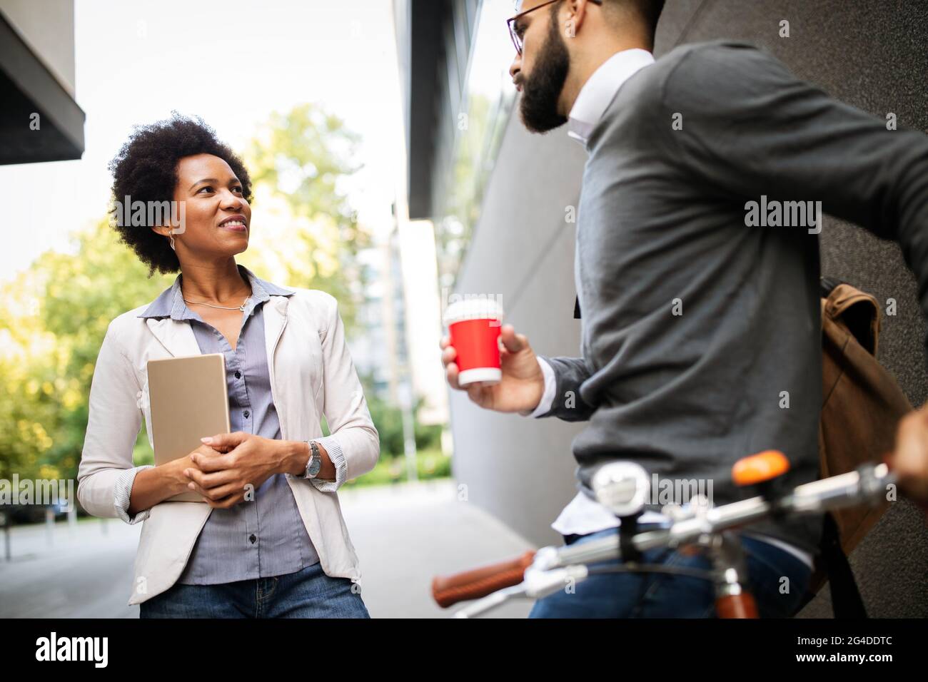 Business people talking outside with coffee, break relaxing time ...