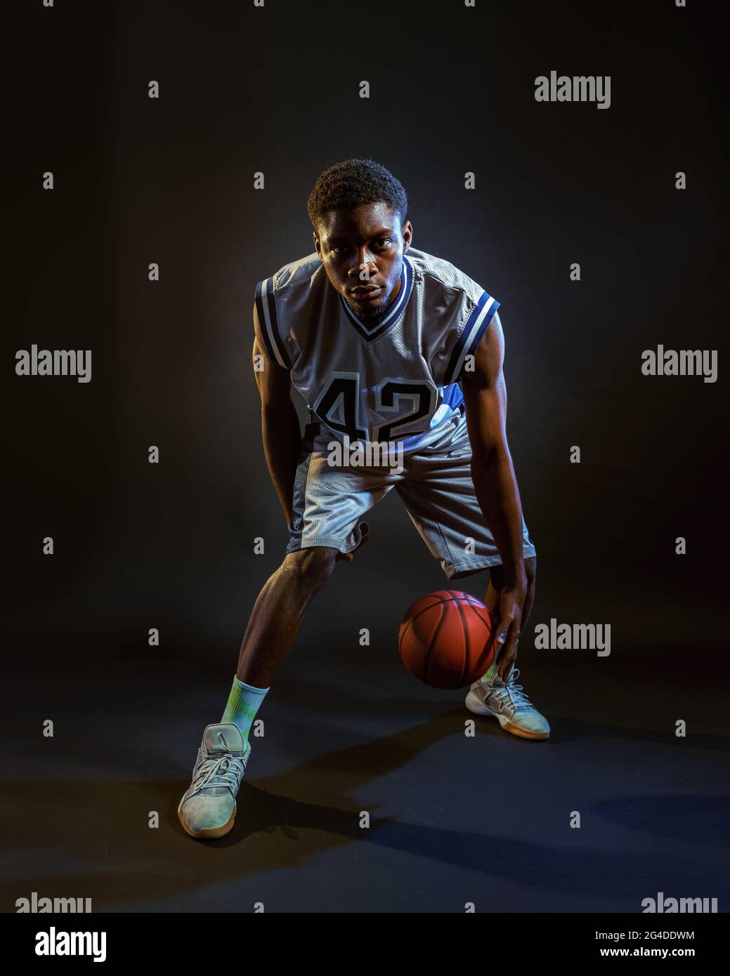Basketball player with ball, practicing in action Stock Photo - Alamy
