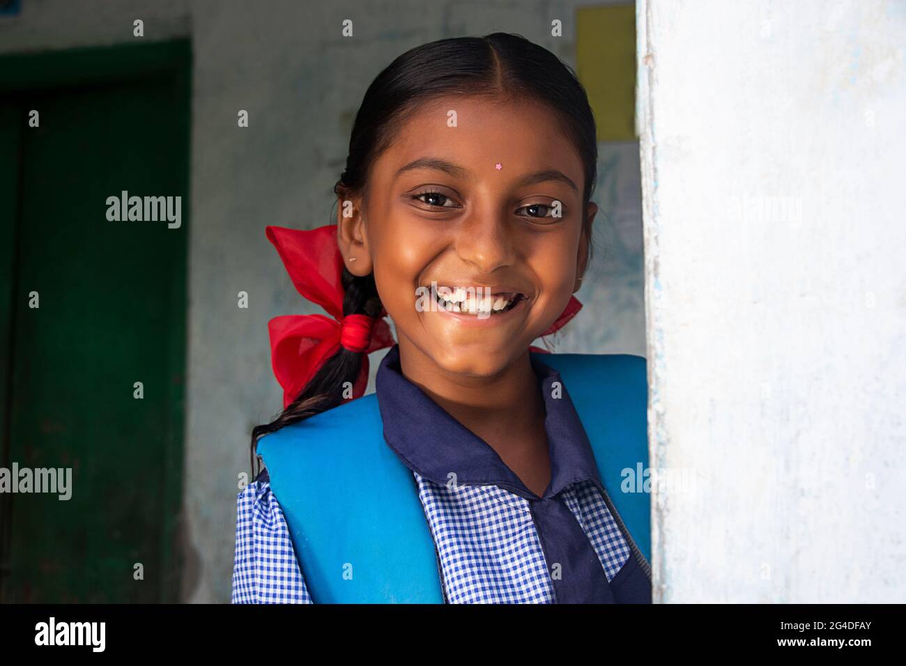 portrait of a rural school girl smiling and standing in school Stock ...