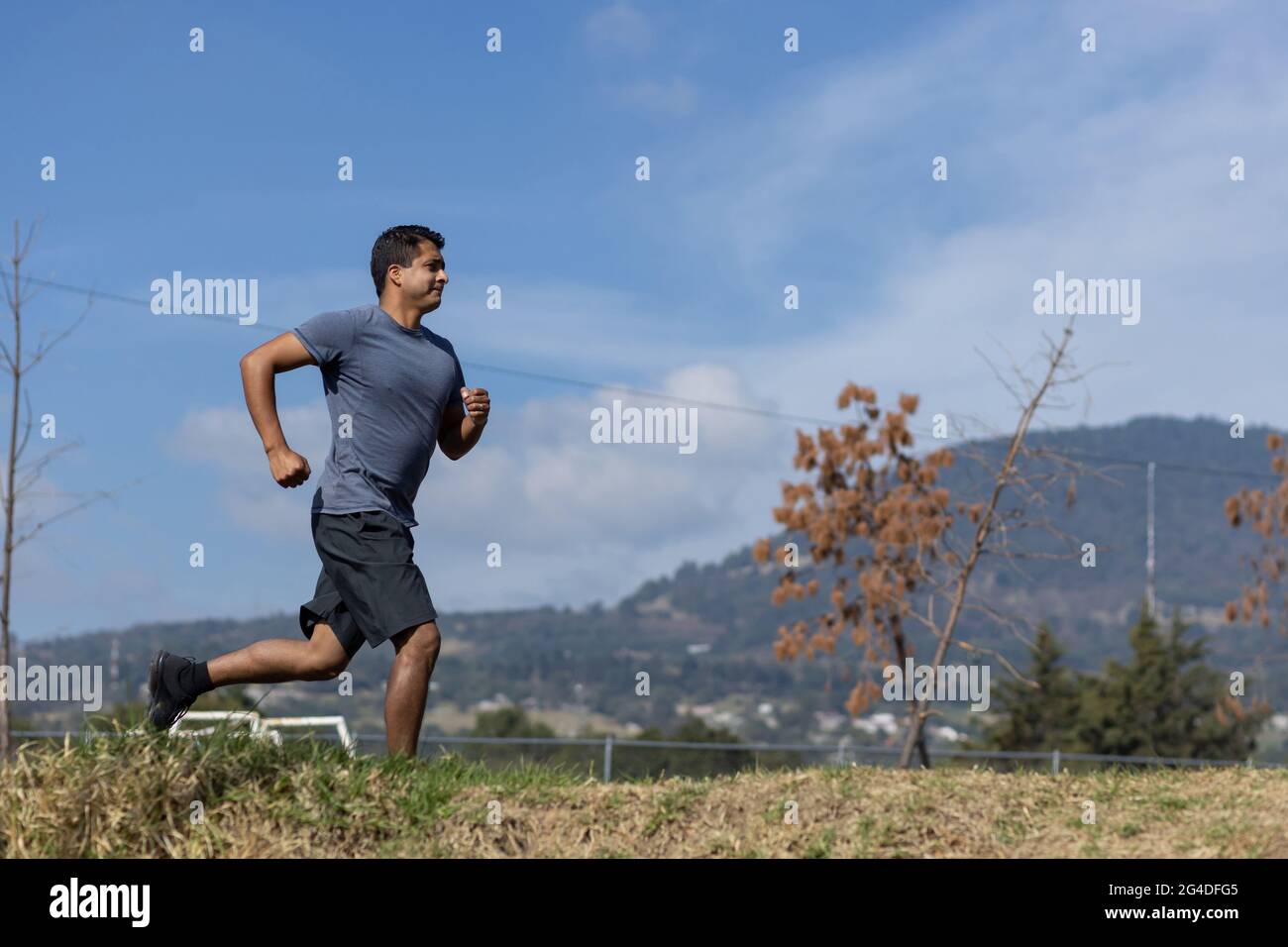 Athletic Mexican male running outdoors, Mexico Stock Photo - Alamy