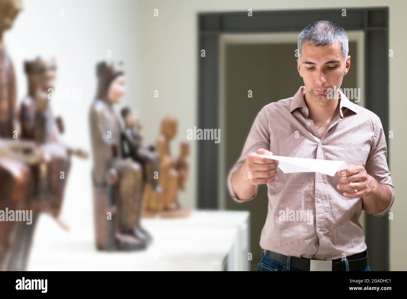 Adult man is visiting museum and looking at the exposition Stock Photo ...