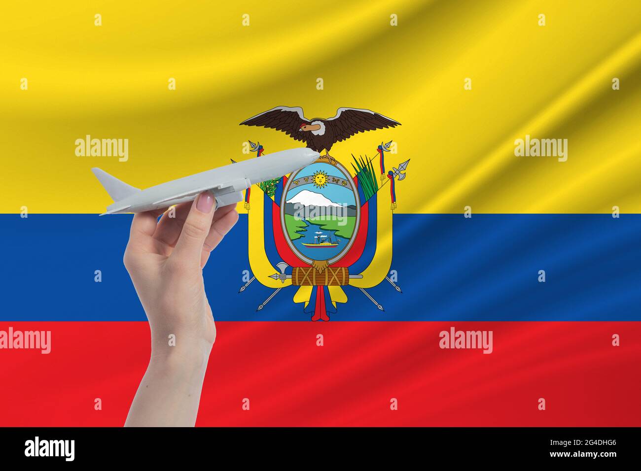 Airplane in hand with national flag of Ecuador Travel to Ecuador Stock ...