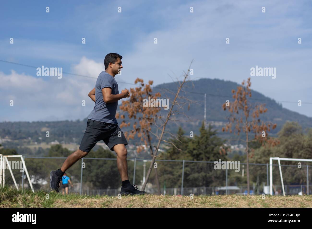 A young Latino man running in the park, Mexico Stock Photo - Alamy