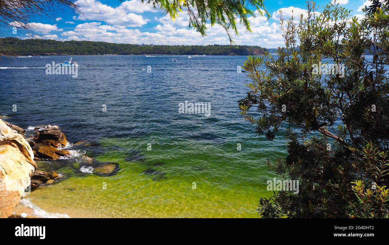 A beautiful seascape of Lady Bay out to the vast ocean with boats and ...