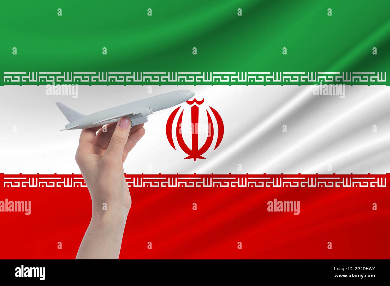 Airplane in hand with national flag of Iran Travel to Iran Stock Photo ...