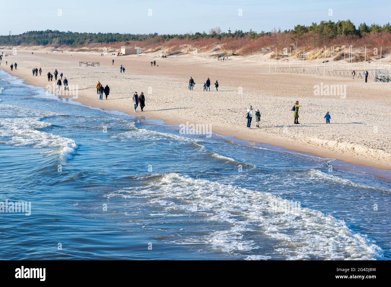 Few of people walking on the beach in spring.People walking on the ...
