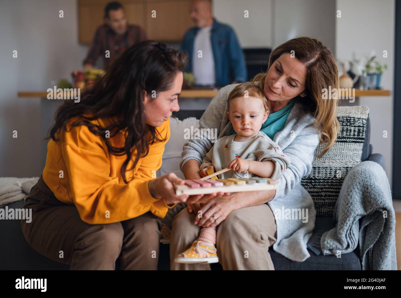 Happy multigeneration family with small baby indoors at home, visiting ...