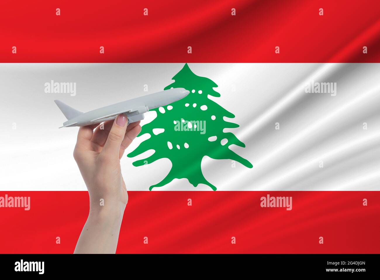 Airplane in hand with national flag of Lebanon. Travel to Lebanon Stock ...
