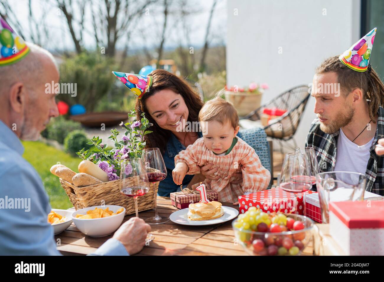 Happy multigeneration family outdoors in garden at home, birthday ...