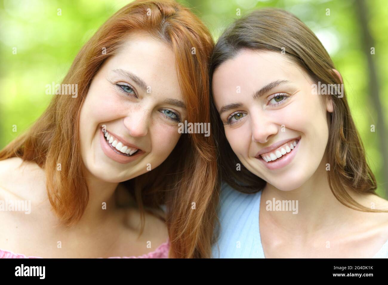Front view portrait of two happy women friends with perfect smile ...