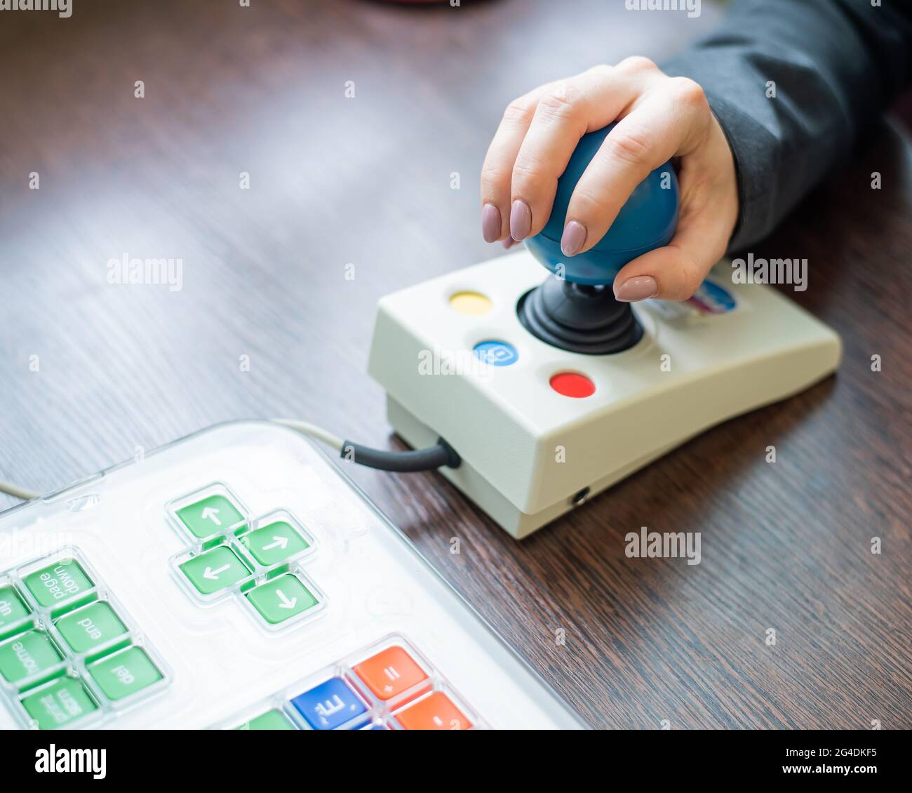 Woman with cerebral palsy works on a specialized computer mouse Stock ...