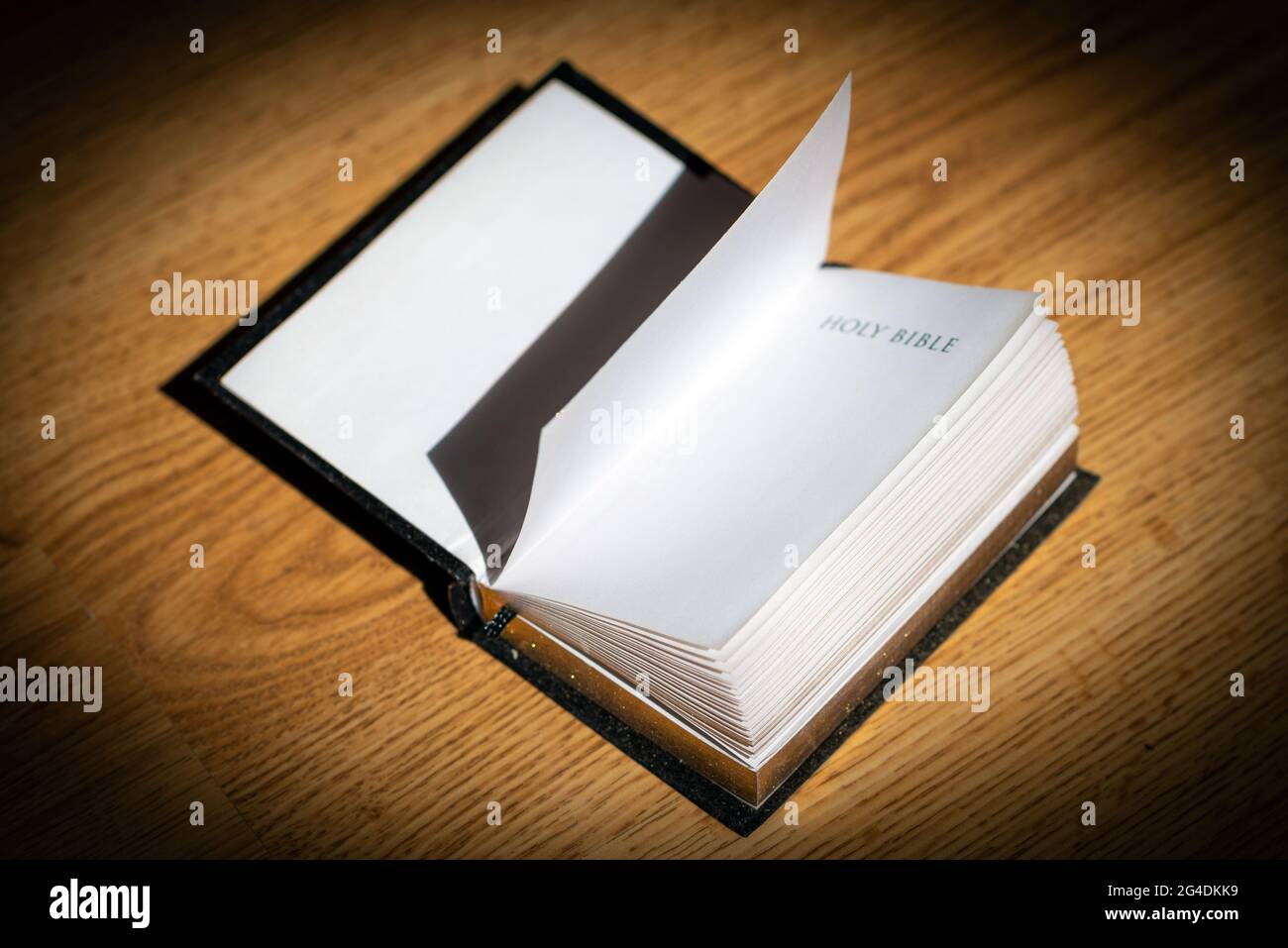 Open Holy Bible on a brown wooden table.Open Holy Bible top view ...
