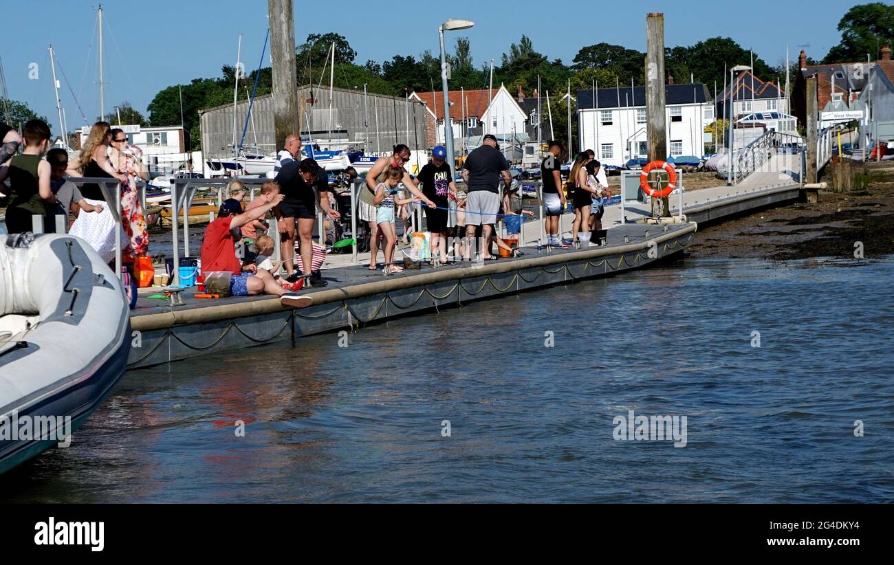 Children happily crab fishing in the sun of a jetty in the sun Stock ...