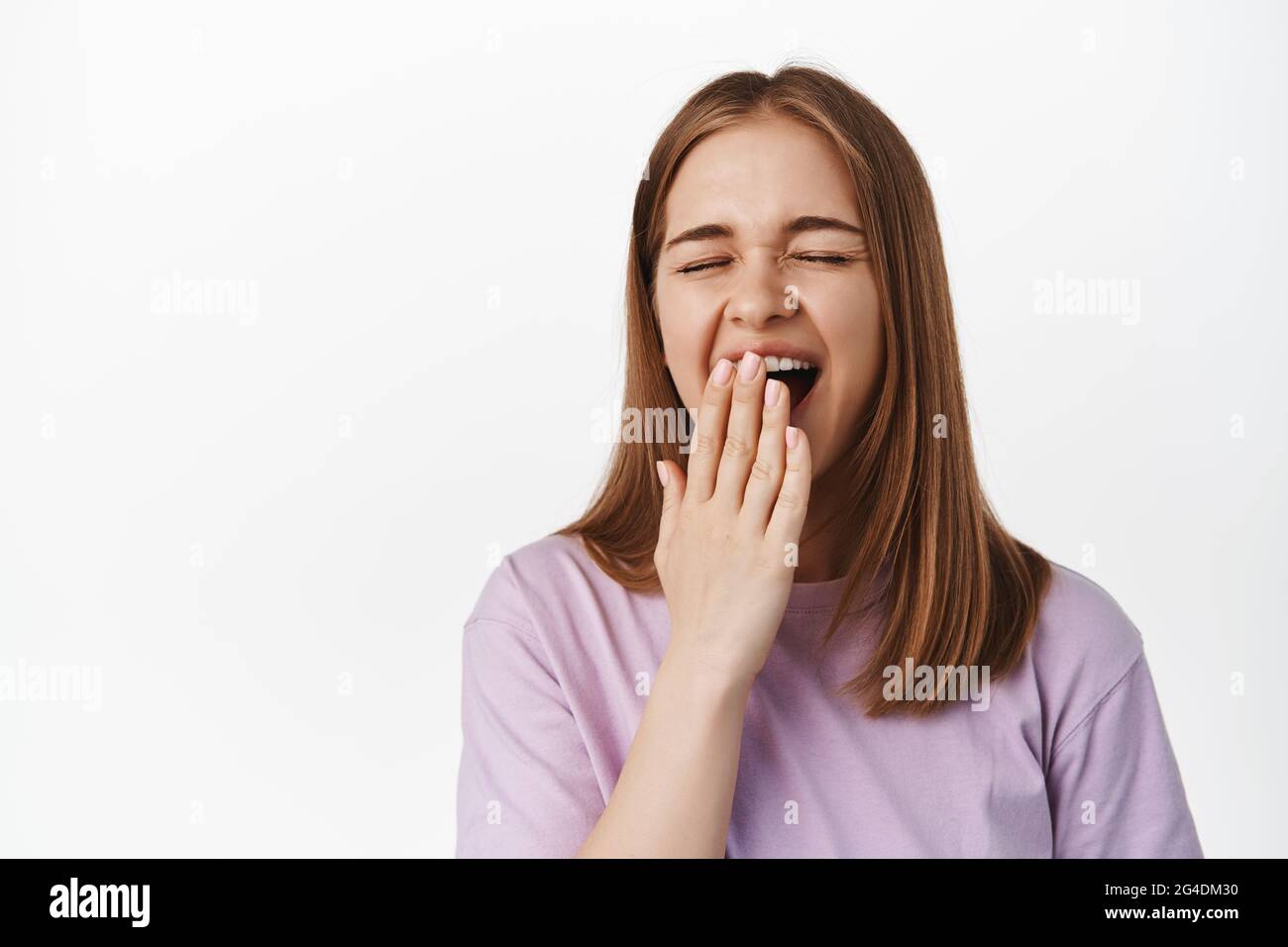 Close up of young woman yawning, student tired during exams, waking up ...