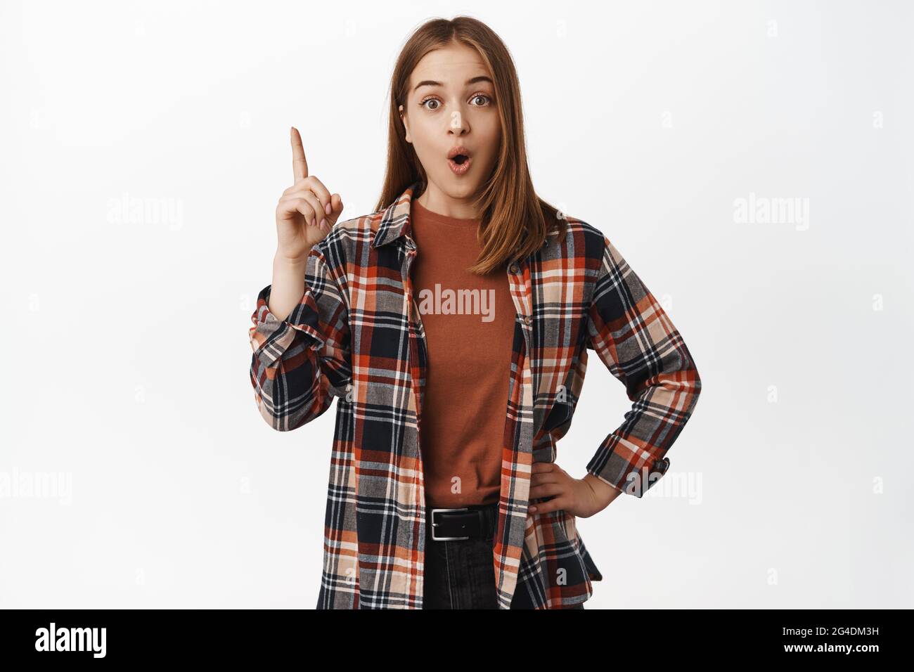 Eureka. Young excited woman gasp in awe, pointing finger up with ...