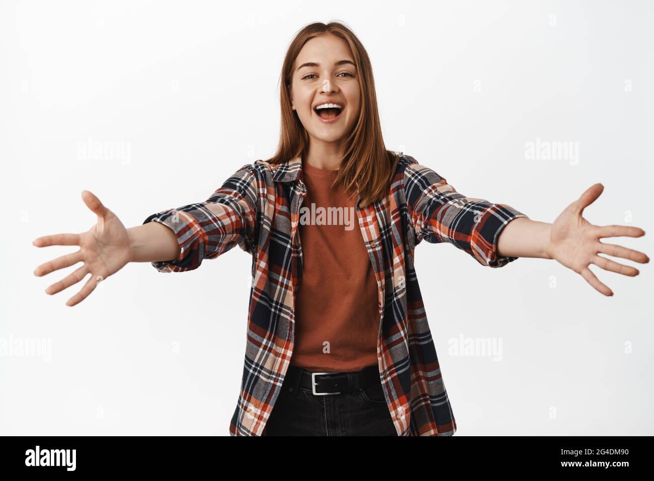 Welcome. Hostile happy girl extends hands in warm welcome, smiling and ...