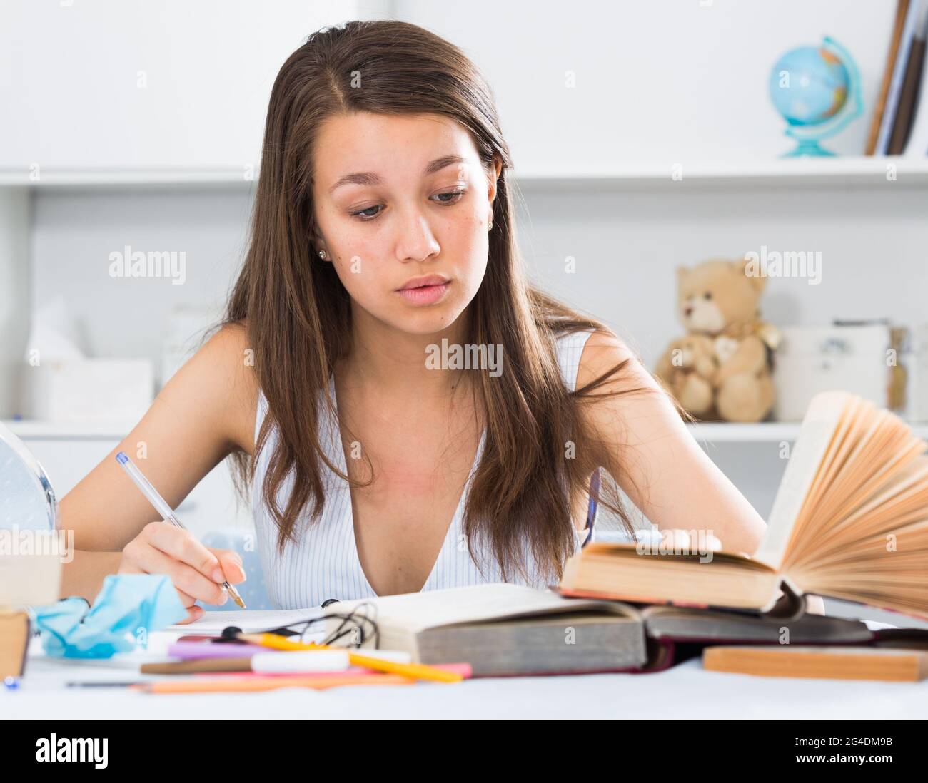 Female student is writing a review of novel Stock Photo - Alamy