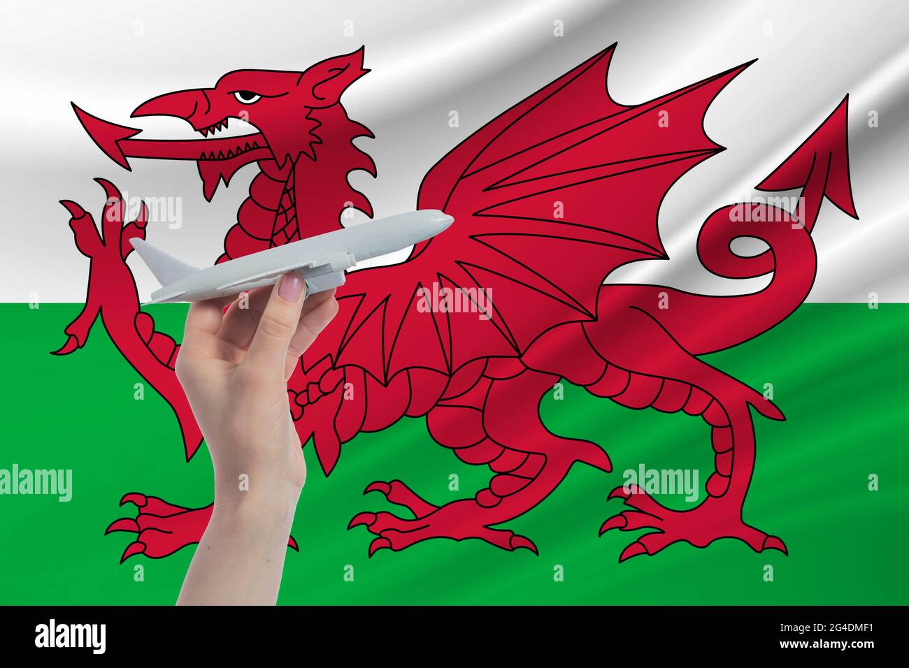 Airplane in hand with national flag of Wales. Travel to Wales Stock ...