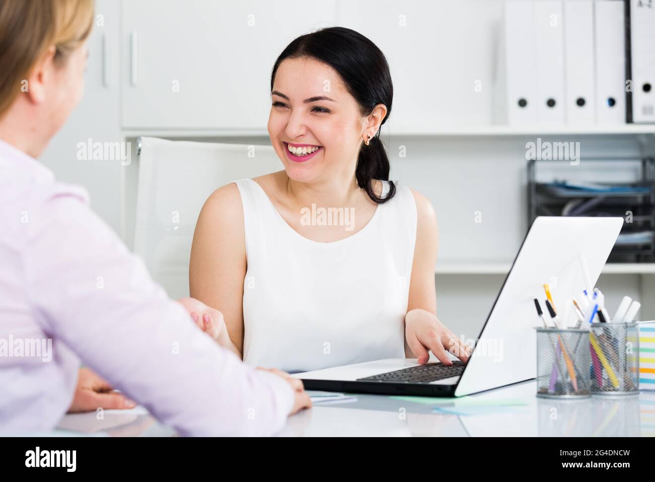 Female manager with client Stock Photo - Alamy