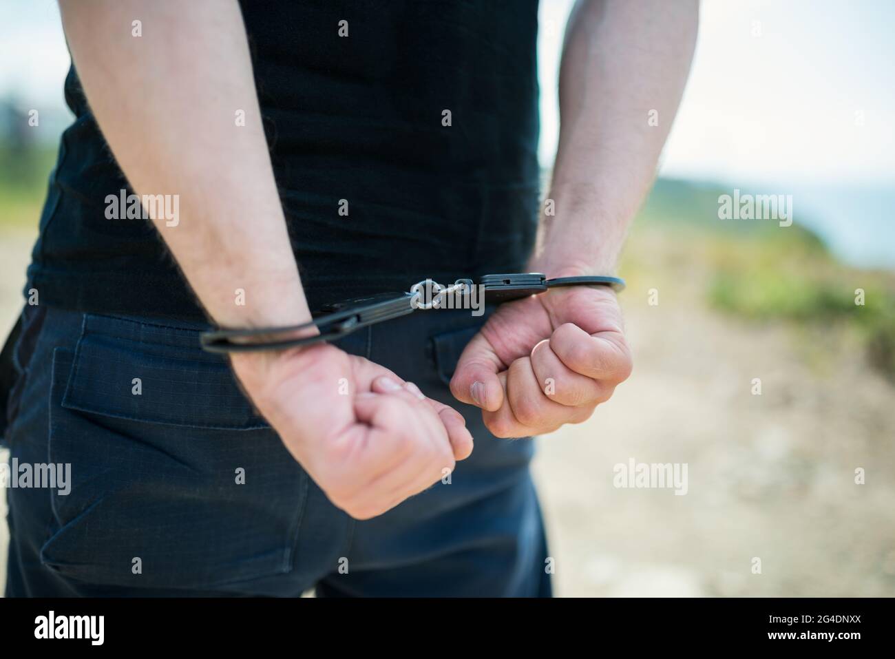 Handcuffed behind back prison hi-res stock photography and images - Alamy