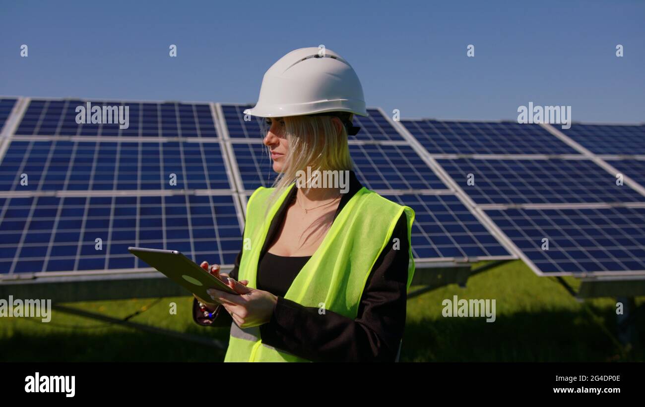 Female ecological engineer uses digital tablet and collects efficient ...