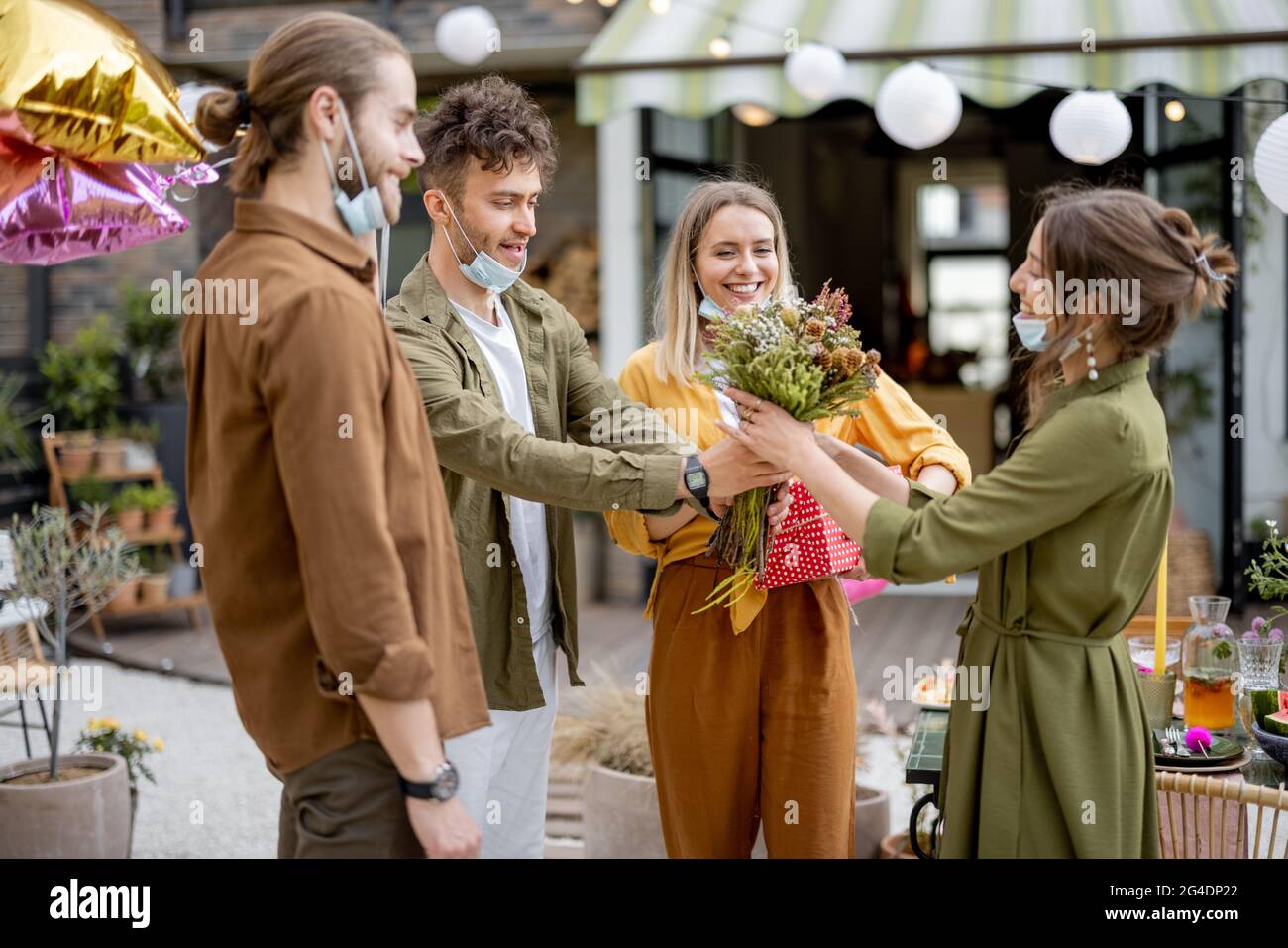 Young adult friends gathering for birthday party at the backyard of ...