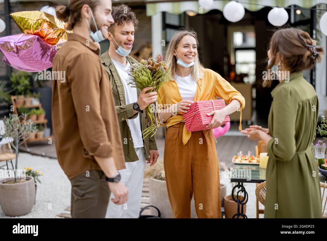 Young adult friends gathering for birthday party at the backyard of ...
