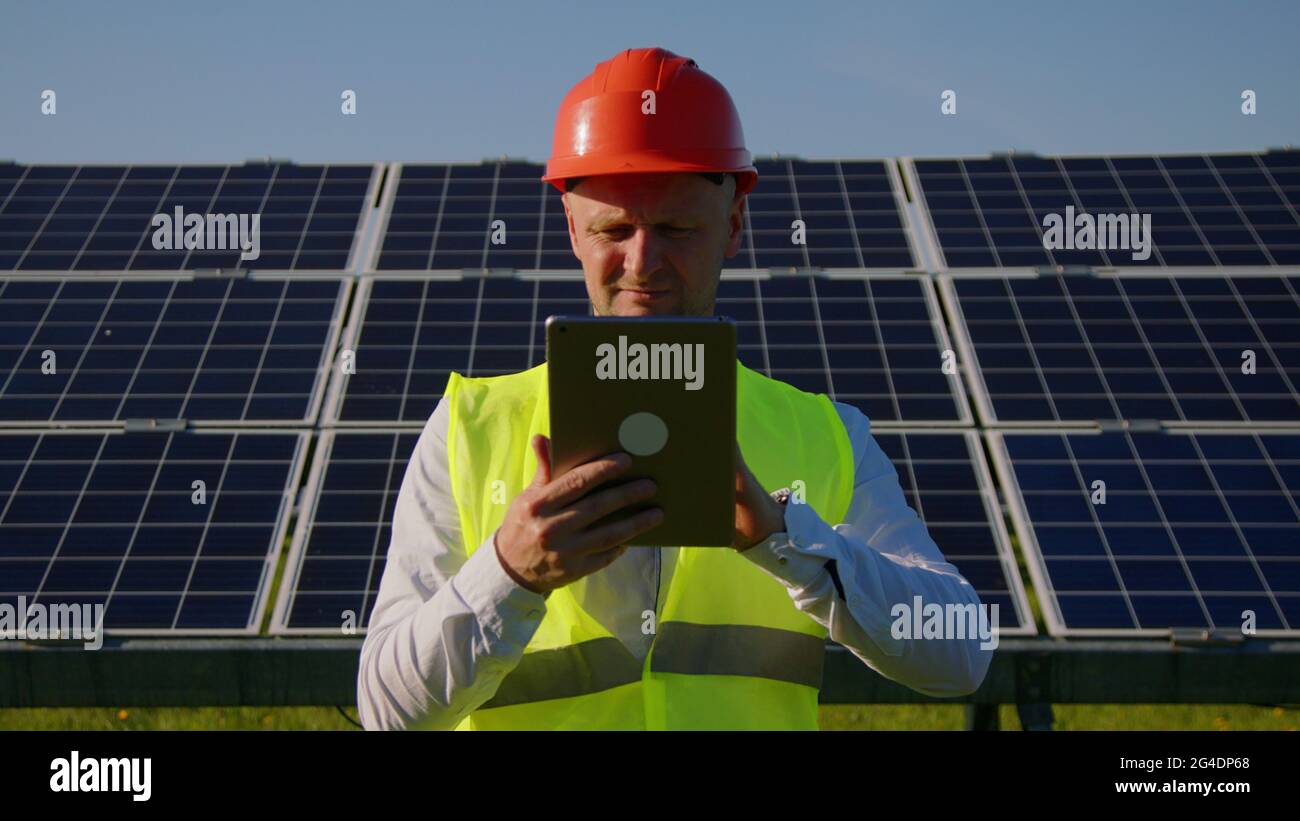 Engineer working use tablet near solar batteries construction renewable ...