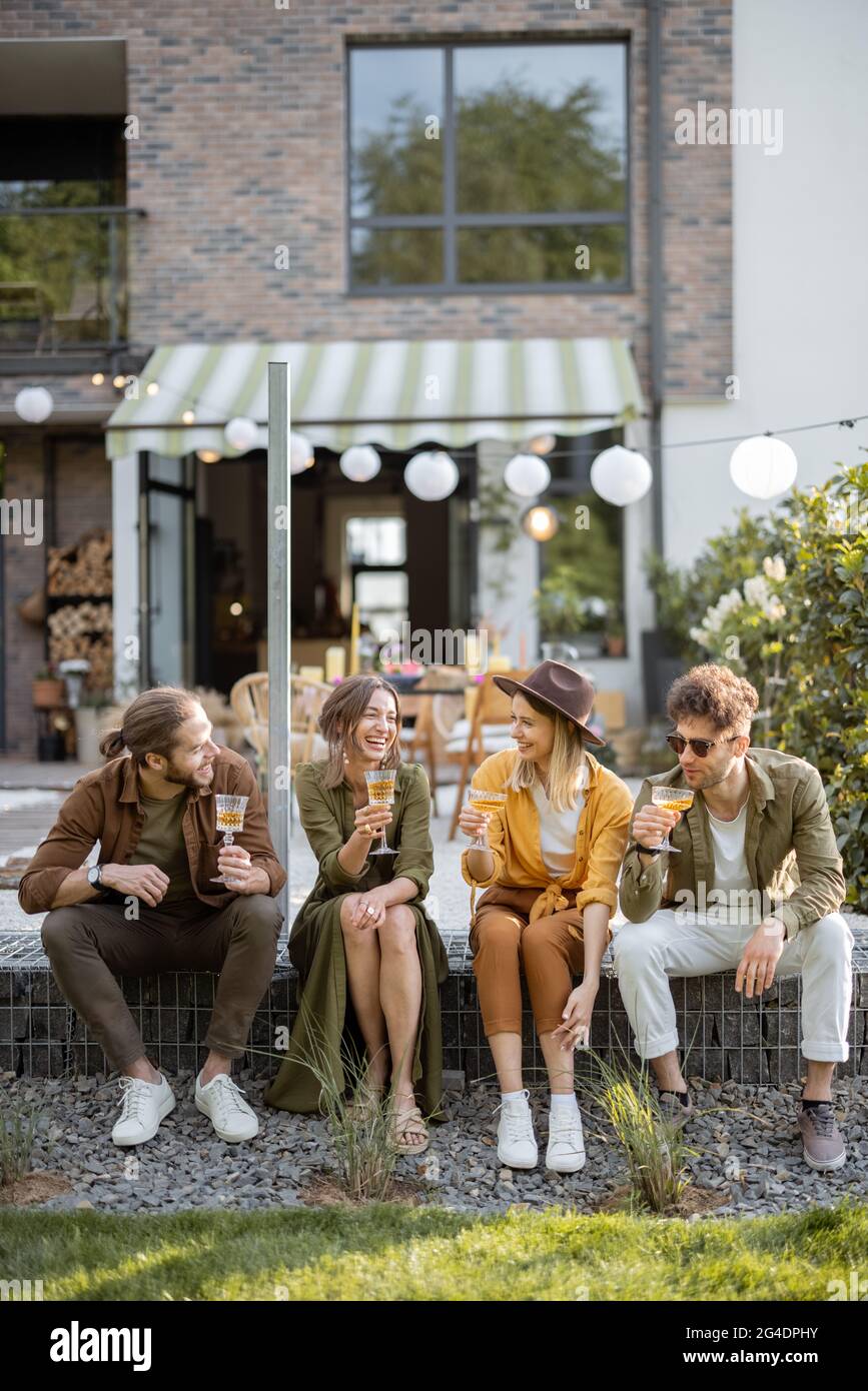 Friends gathering together on a porch of a country house Stock Photo ...