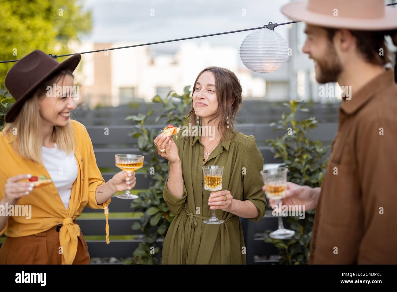 Happy friends talking eating snacks hi-res stock photography and images ...