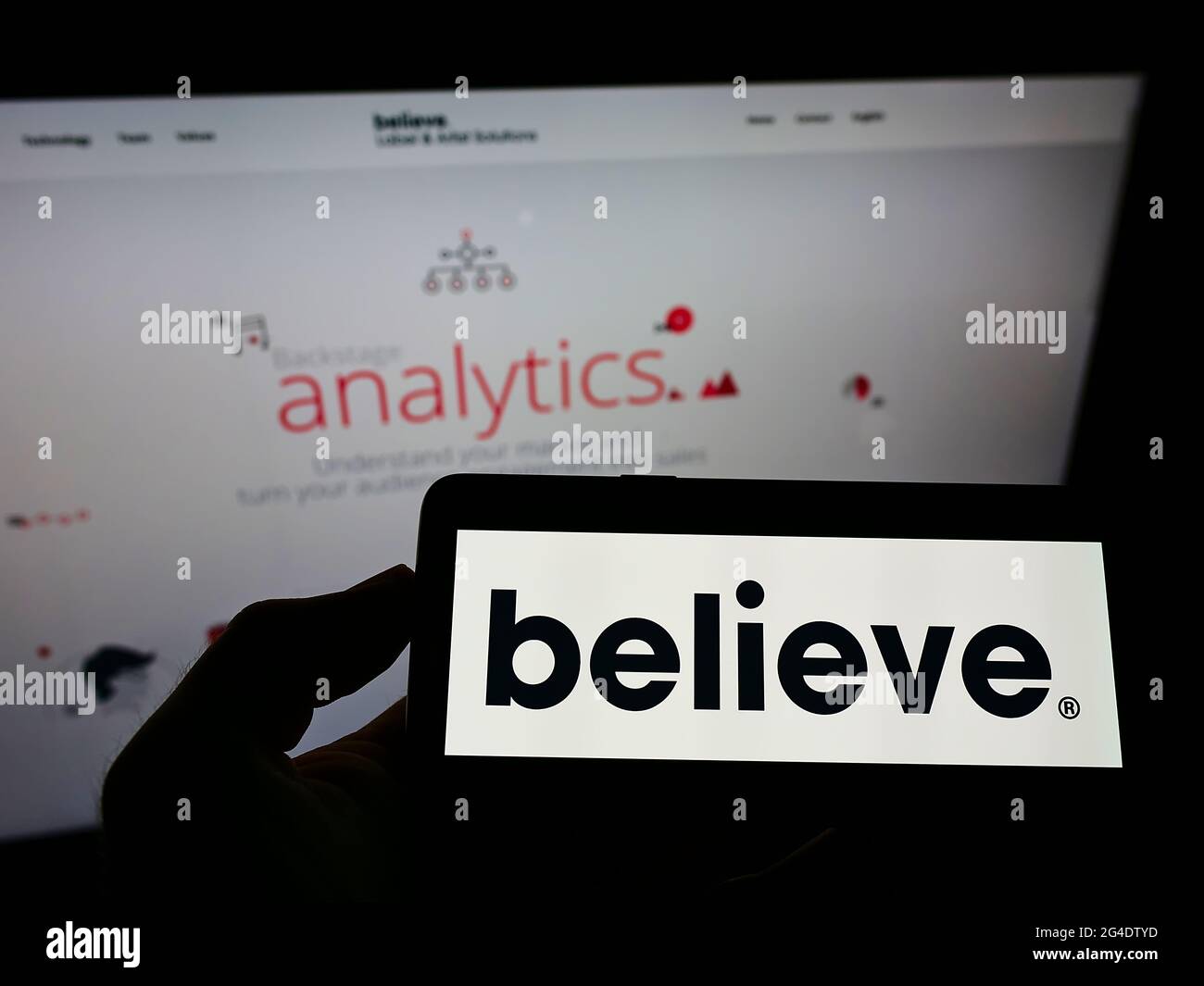 Person holding cellphone with logo of French record label Believe ...