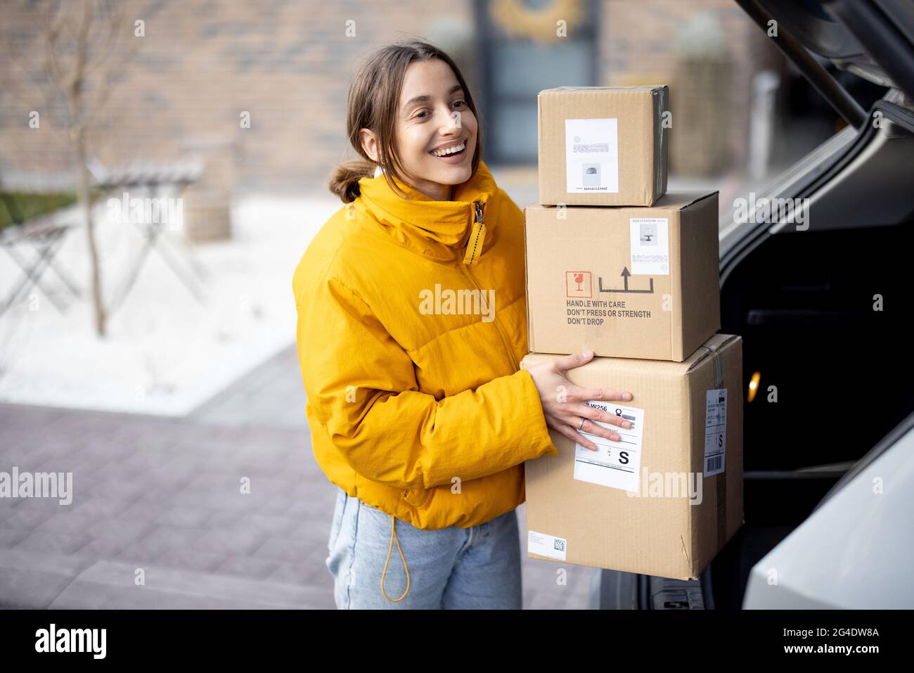 Woman arrives home with parcels Stock Photo - Alamy