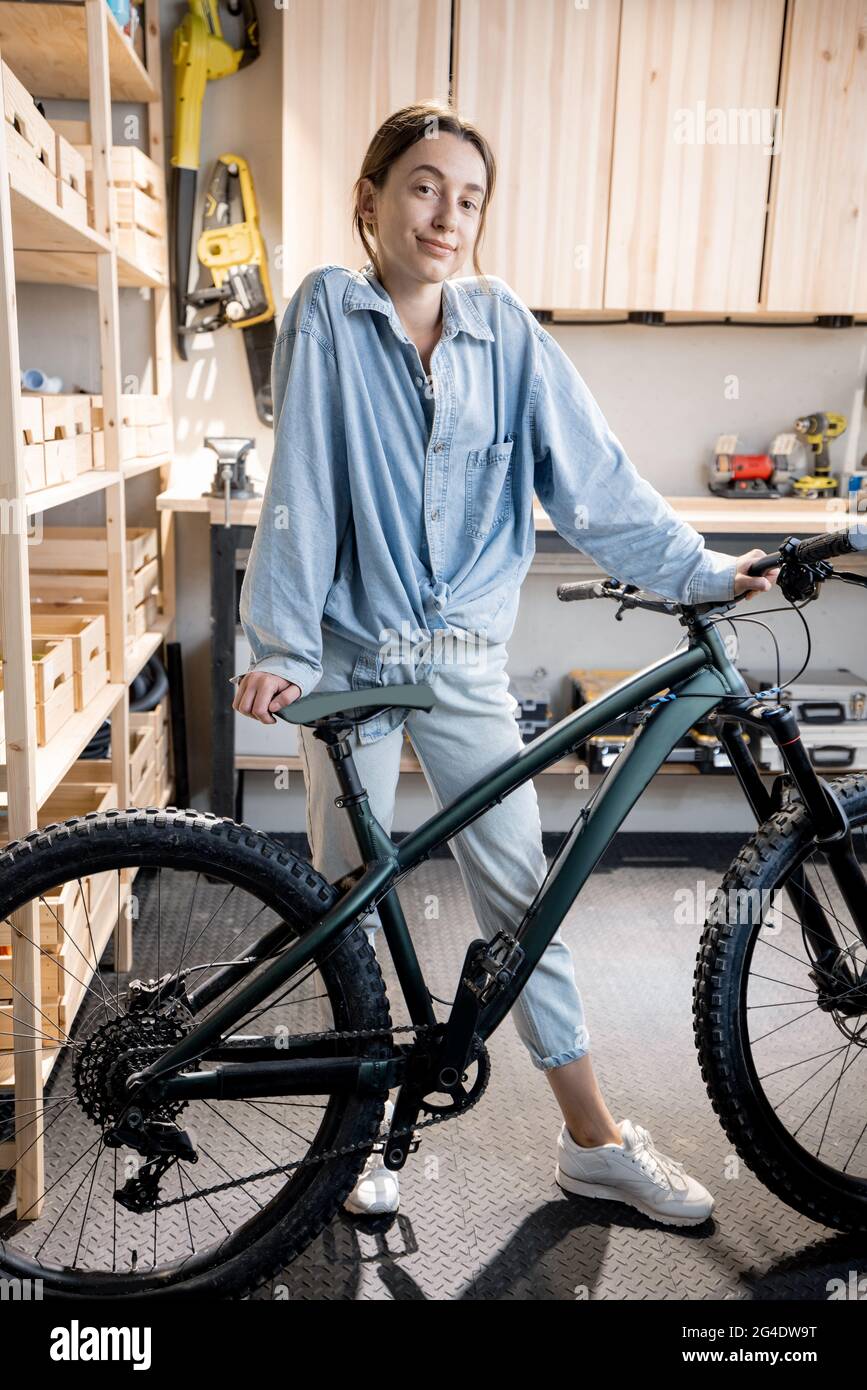 Woman repairing bicycle home fixing hi-res stock photography and images ...